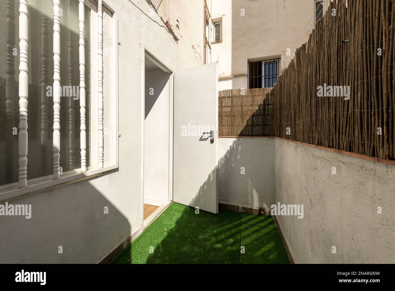 Small terrace of a house on the ground floor with artificial grass ...