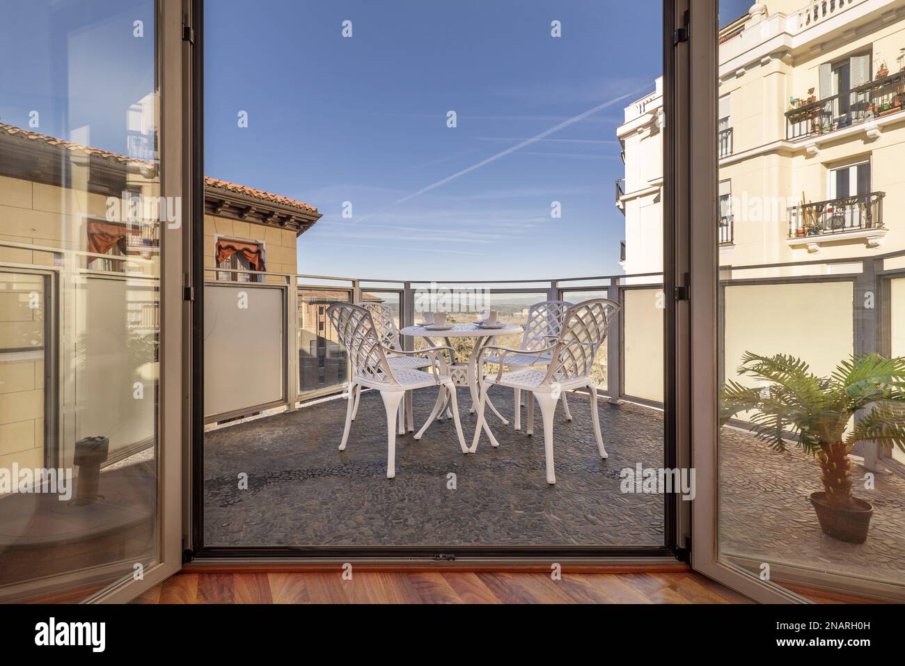 Beautiful image of a terrace with an outdoor circular white table with ...