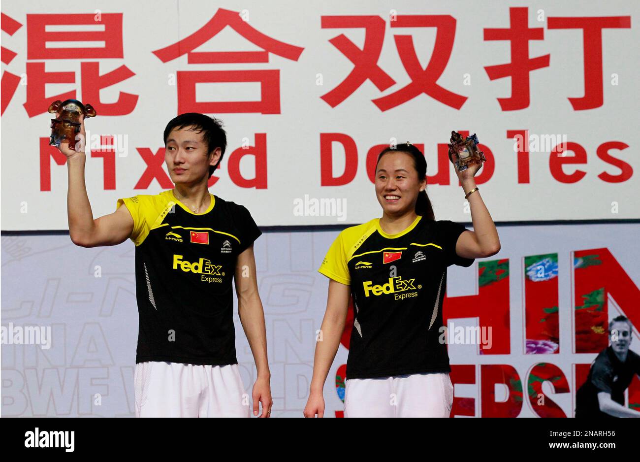 China's Zhang Nan, left, and Zhao Yunlei hold the champion trophies ...