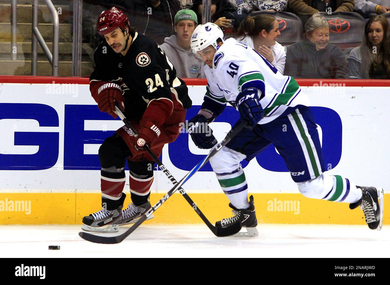 Phoenix Coyotes' Kyle Chipchura (24) battles Vancouver Canucks' Maxim ...