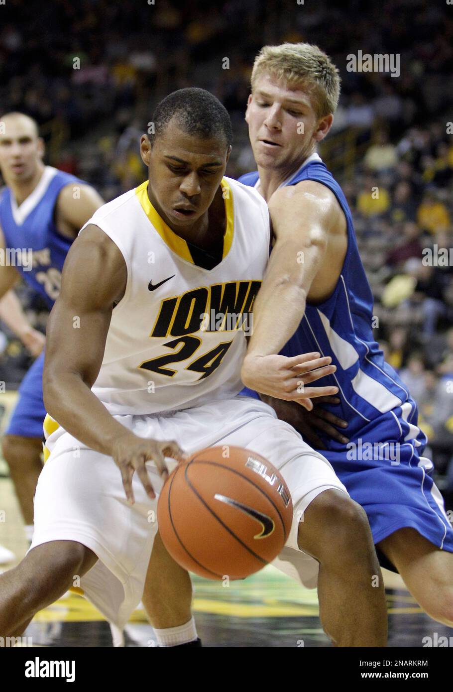 Iowa guard Bryce Cartwright, left, looks to drive past IPFW guard Jonny ...