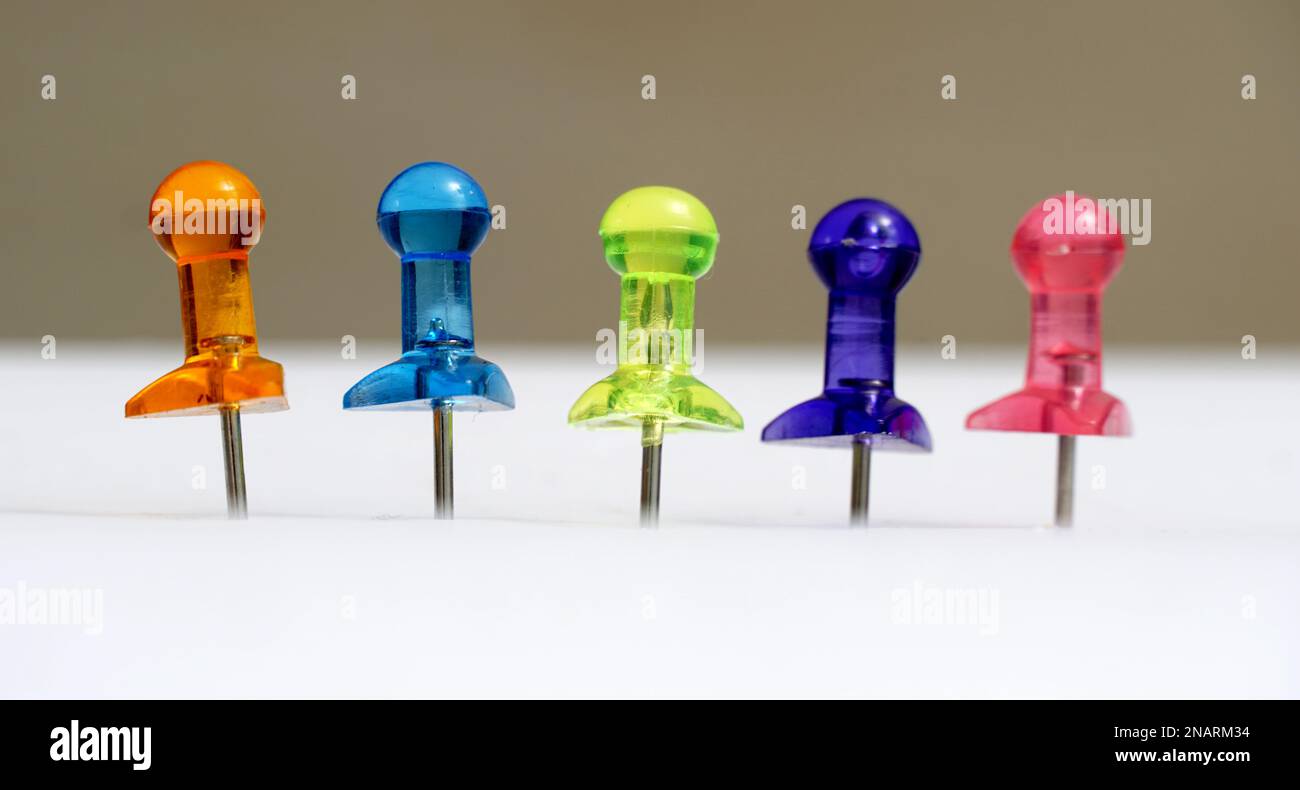 many colorful push pins on white, color concept Stock Photo - Alamy