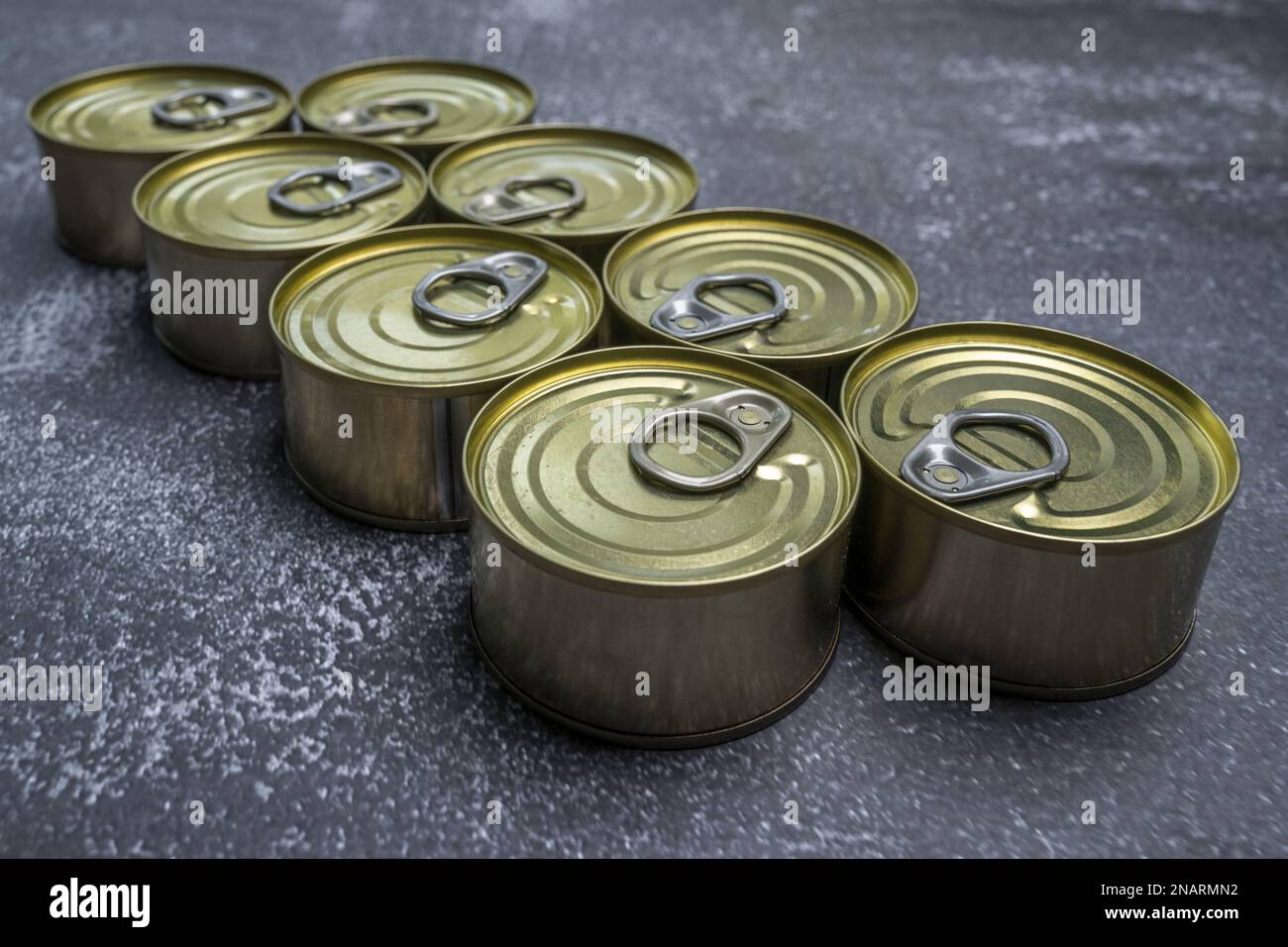 Still life with small circular cans with easy-open rings on a gray ...
