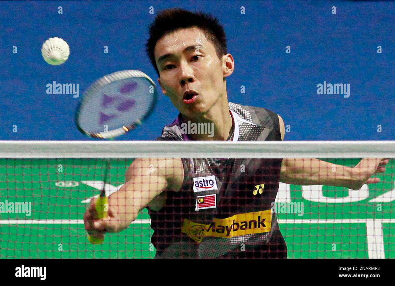 Malaysia's Lee Chong Wei returns the shot against Lin Dan of China ...