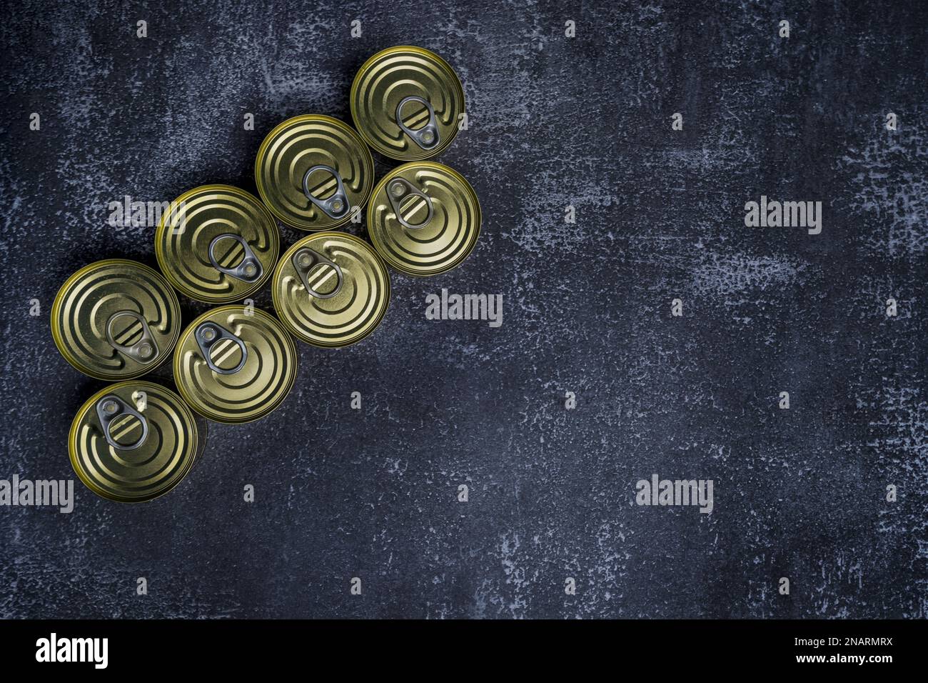 Still life with small circular cans with easy-open rings on a gray ...