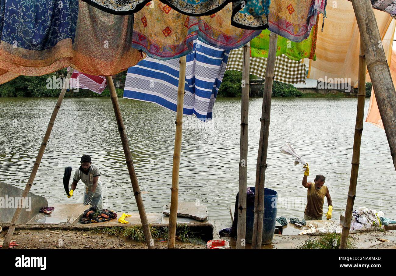 Sri Lankan washermen wash clothes on the banks of river Kelani in ...
