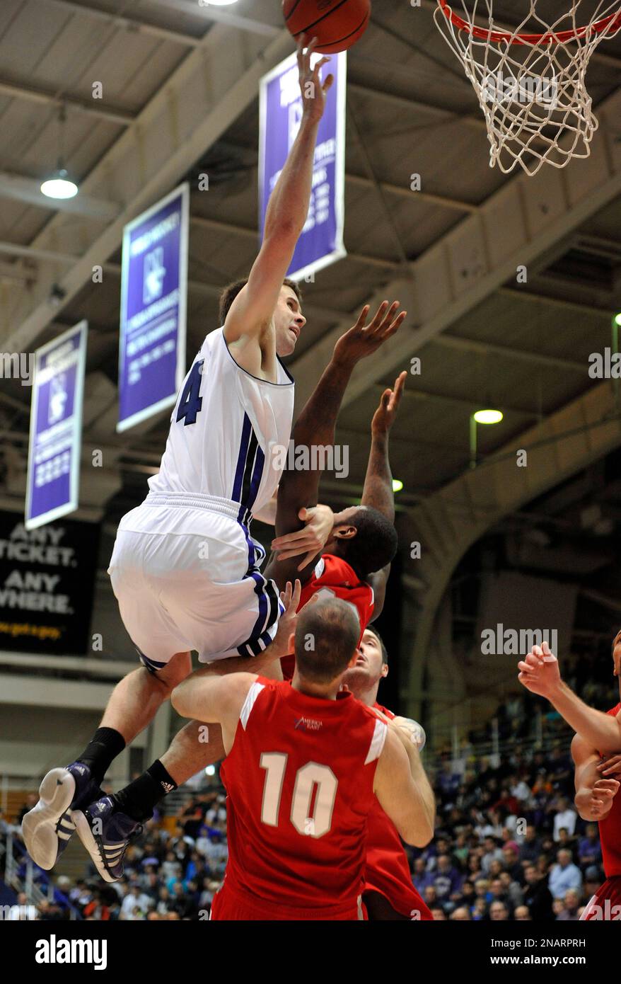 Northwestern forward John Shurna, left, shoots over Stony Brook forward ...