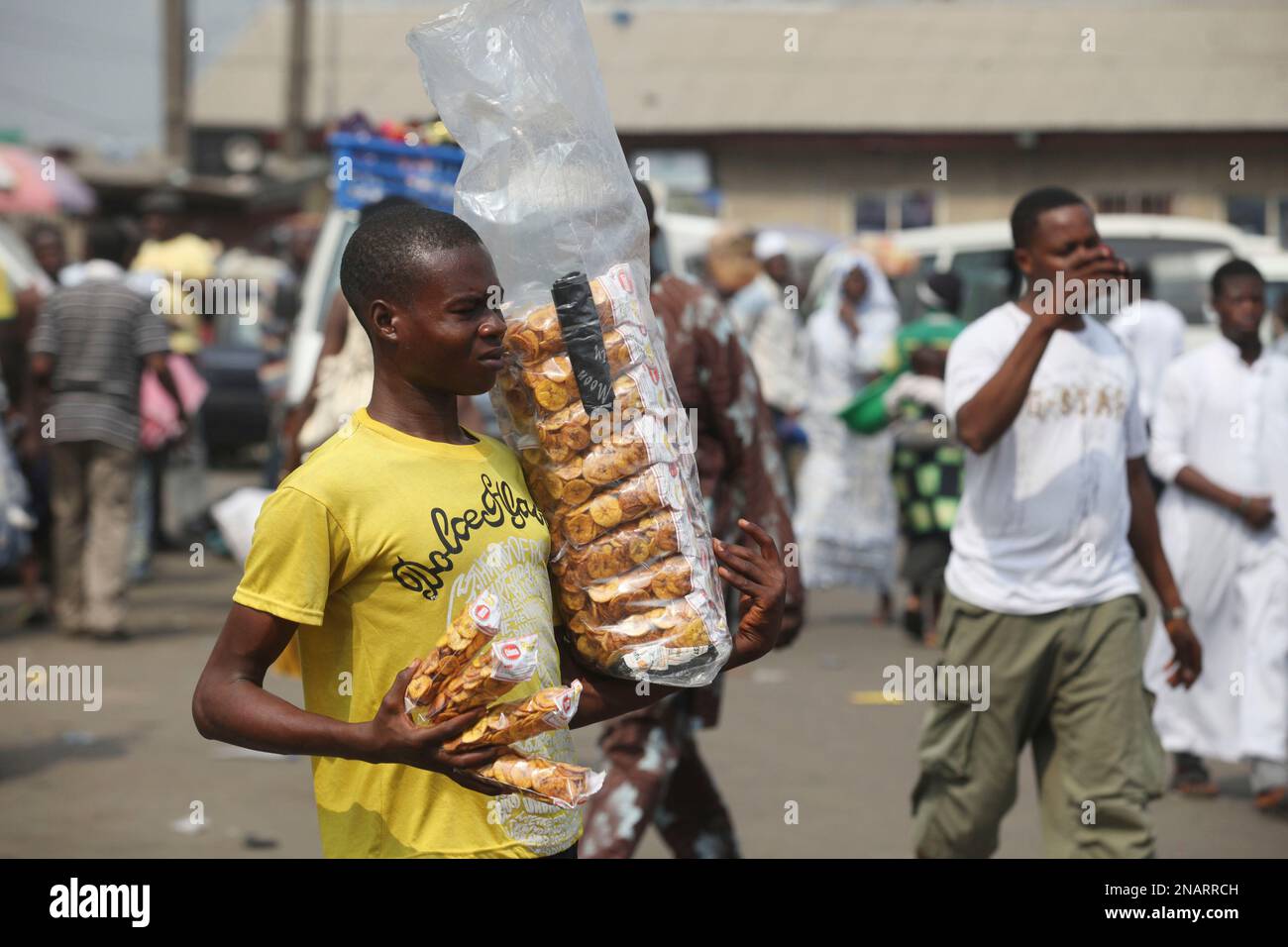 A man sells plantian chips at Ojota bus terminal in Lagos, Nigeria ...