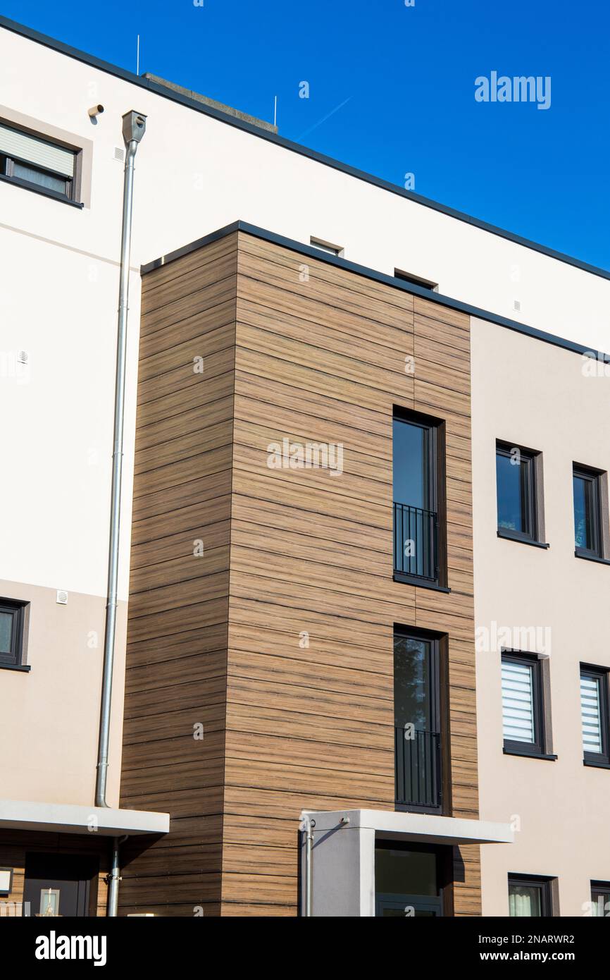 Modern facade with wooden panels on a new apartment building Stock ...