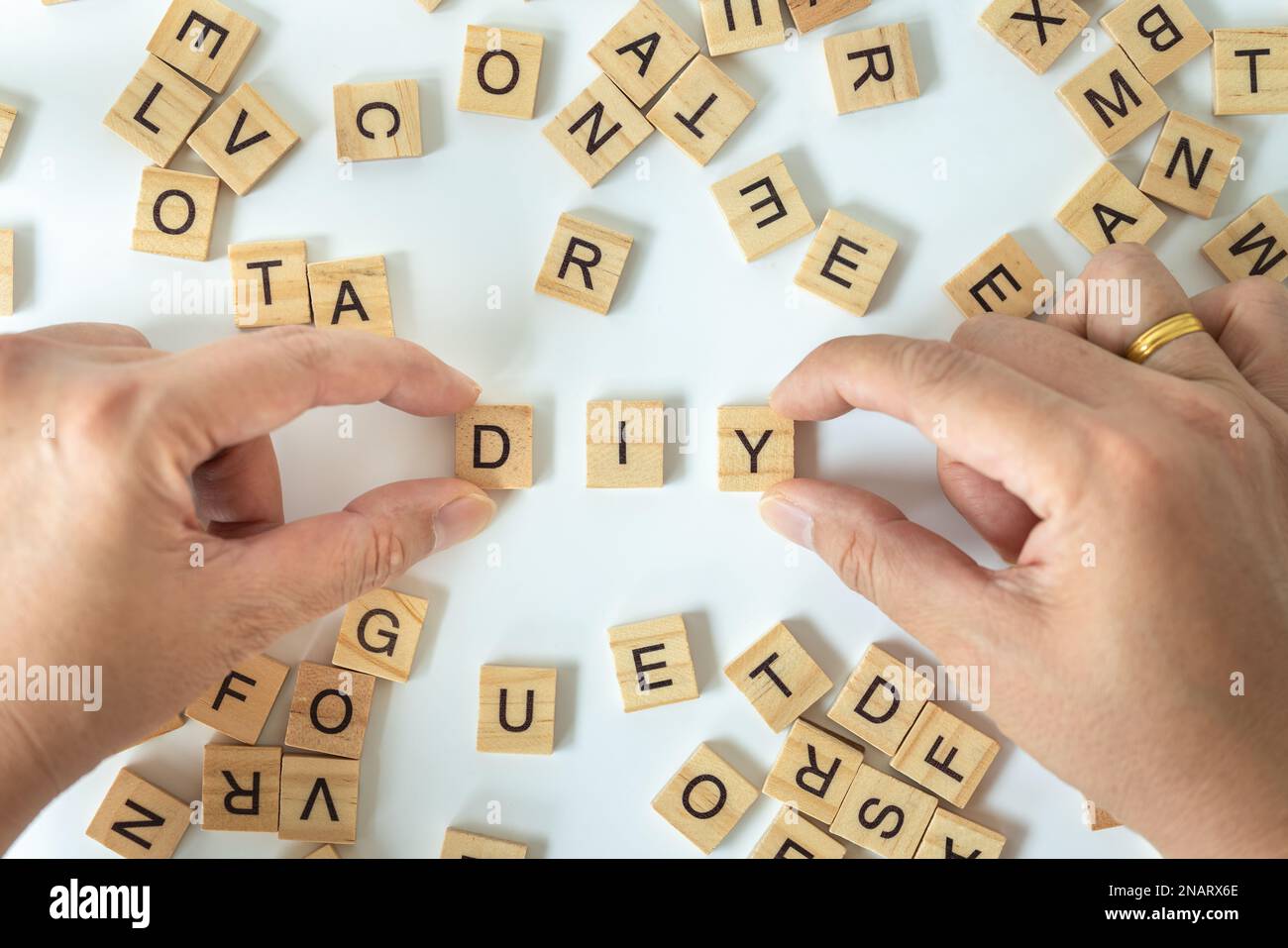 Business and Do It Yourself Concept. Closeup of man hand holding D and ...