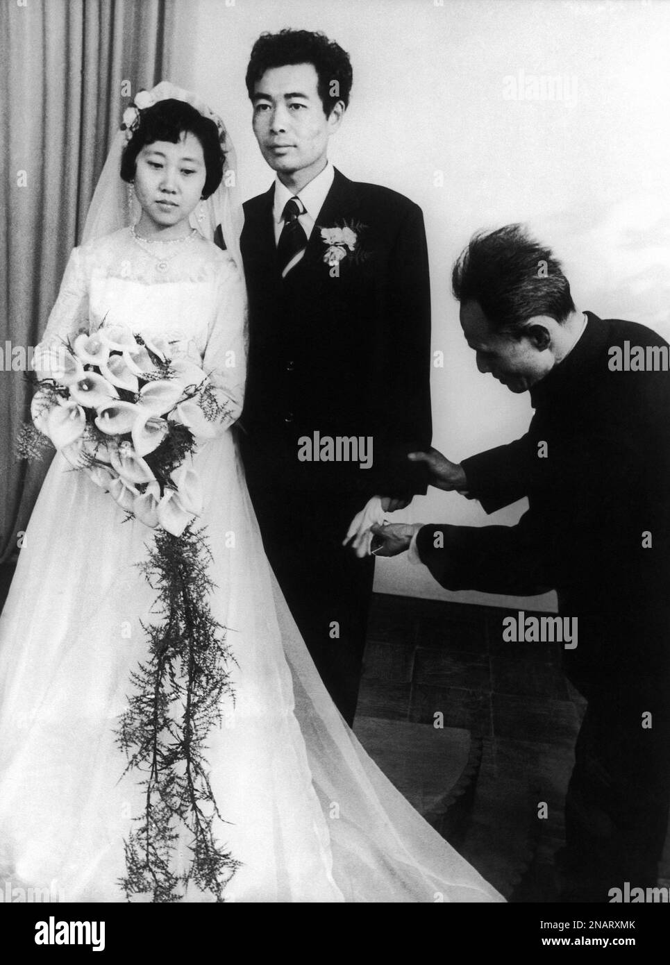 The Shanghai portrait photographer at right wears a Mao suit, but his ...