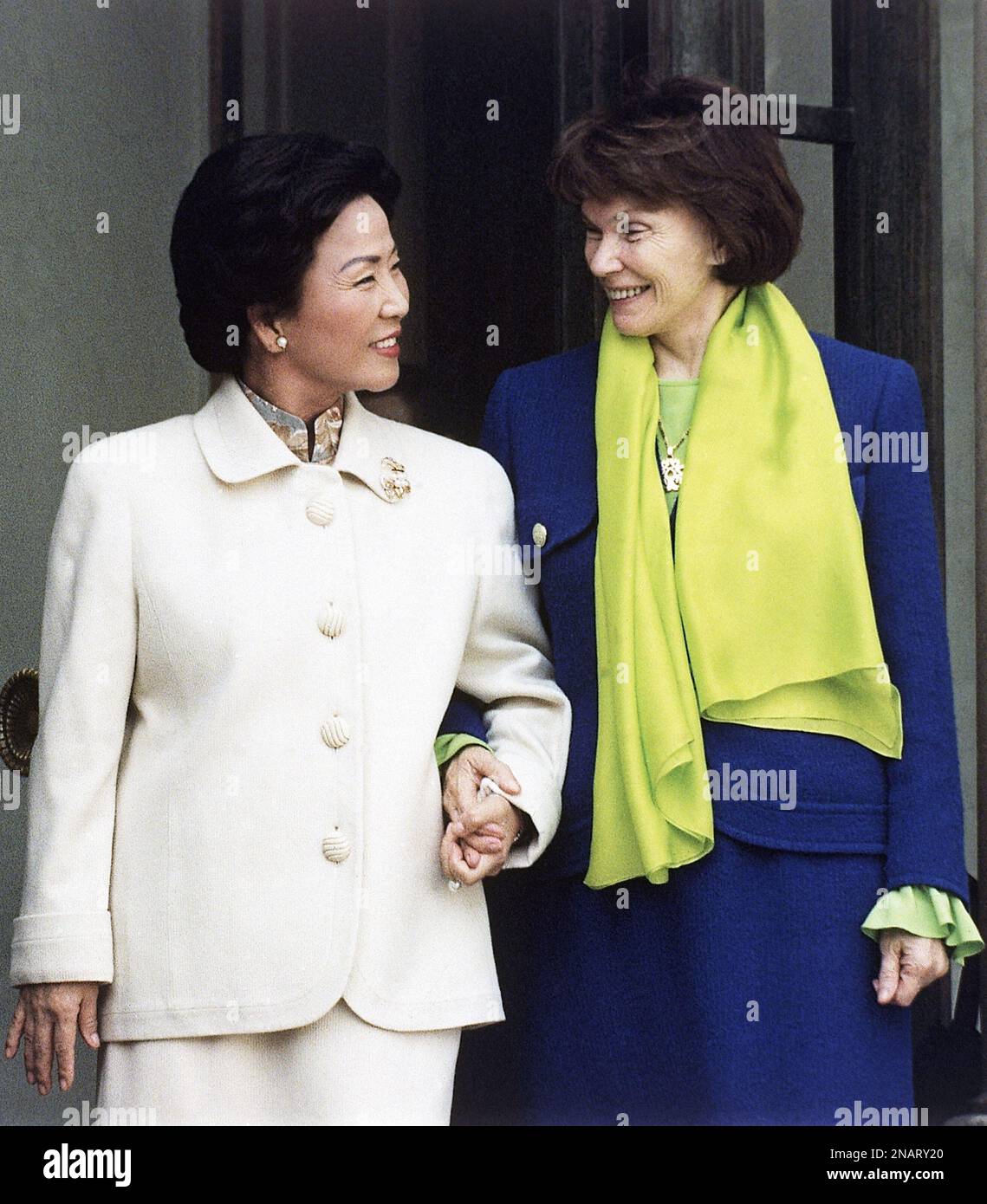French First Lady Danielle Mitterrand, right, holds the hand of her ...