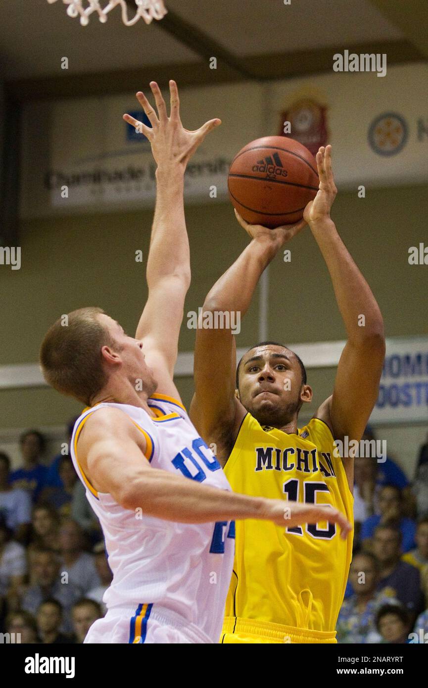 UCLA forward Travis Wear, left, attempts to block a shot by Michigan ...