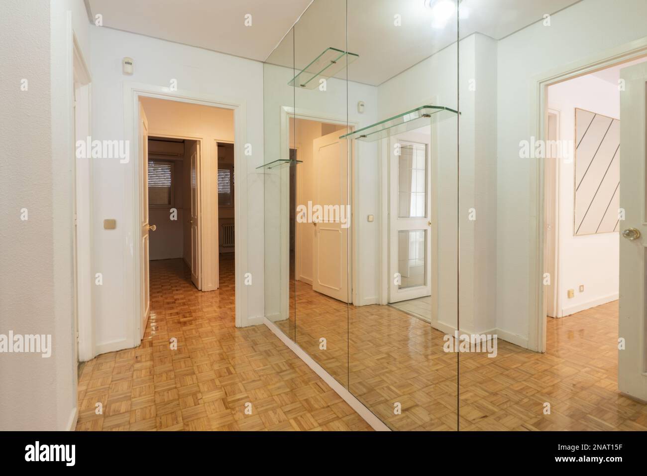 Distribution corridors of a house with light oak flooring and white ...