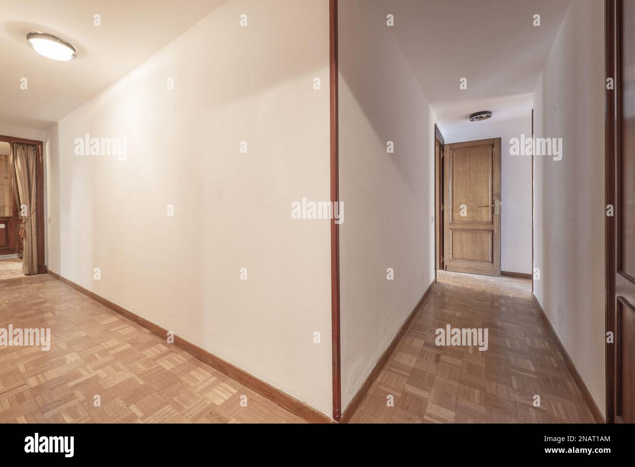 Corridor of a house with oak plank flooring laid in a checkerboard ...