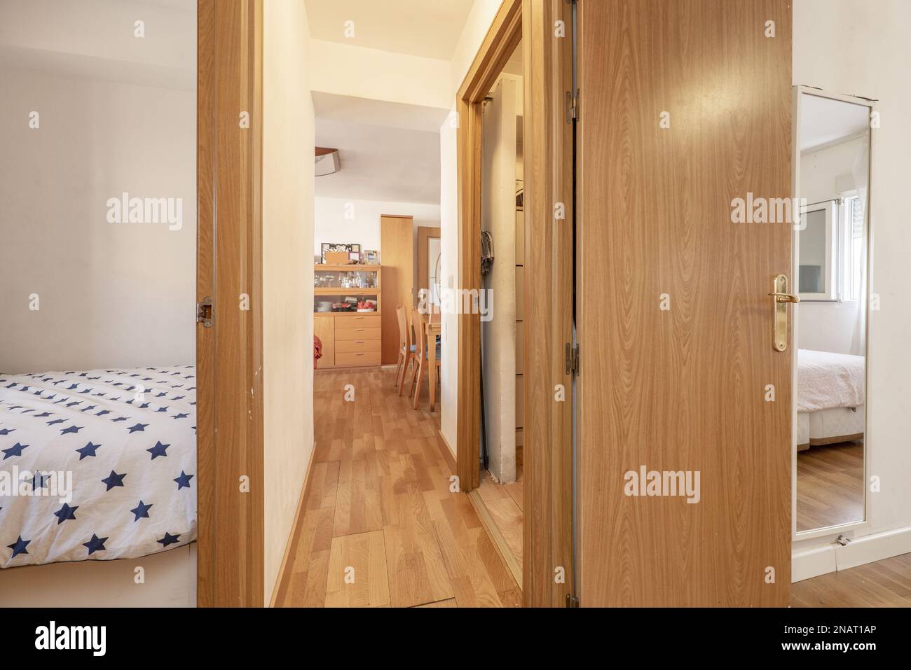 Corridor of a house with wooden floors and oak access doors to ...