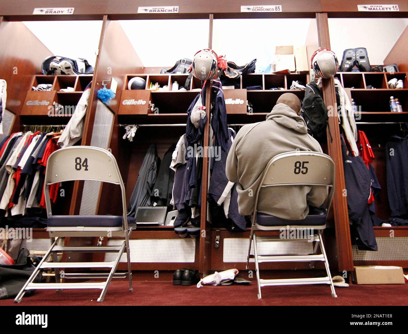 New England Patriots receiver Chad Ochocinco sits alone during a media ...