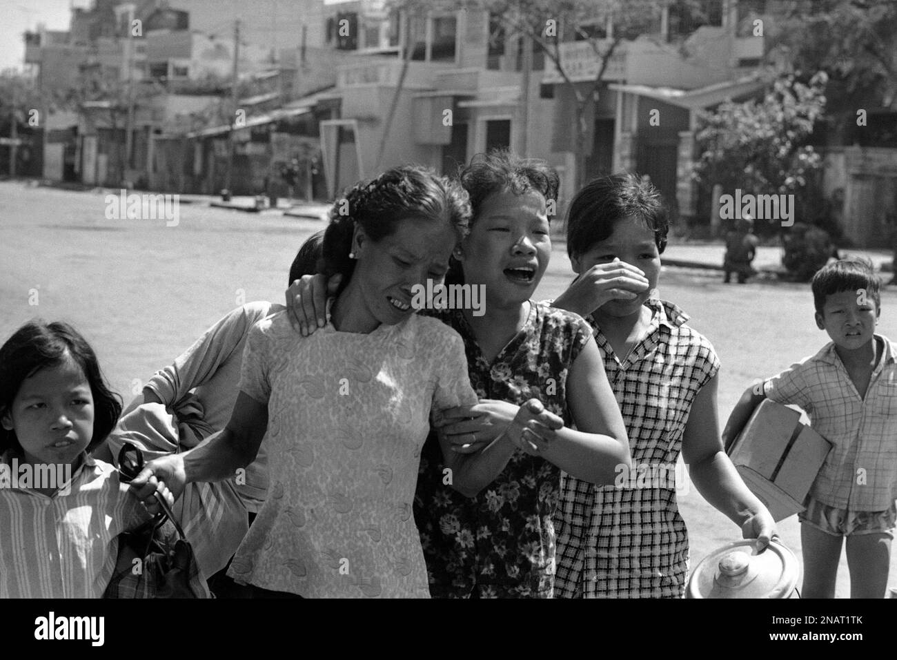 Three Vietnamese women cry as they leave their homes in the western ...