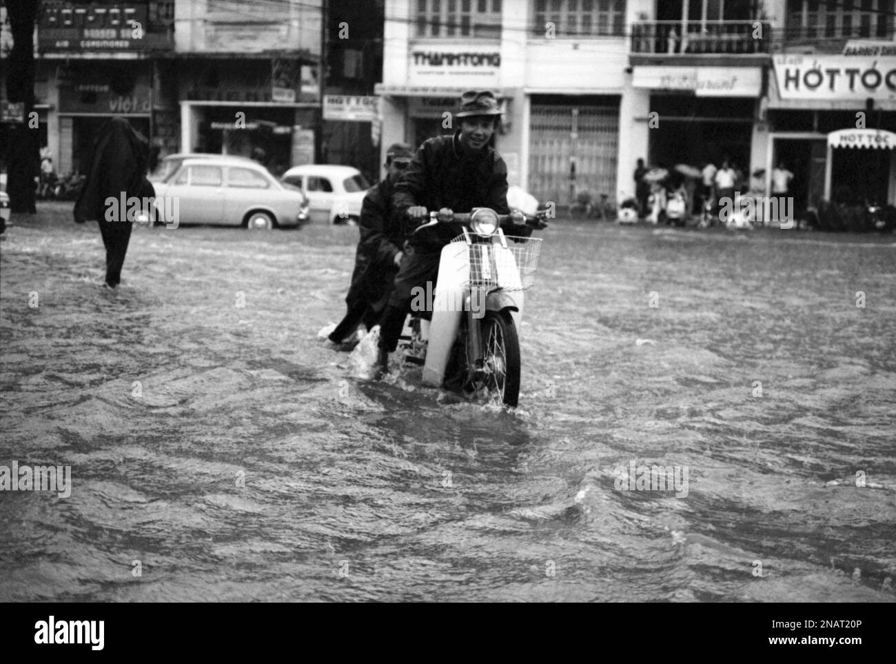 Guy on motor bike during monsoon in Saigon on May 30, 1968. (AP Photo ...