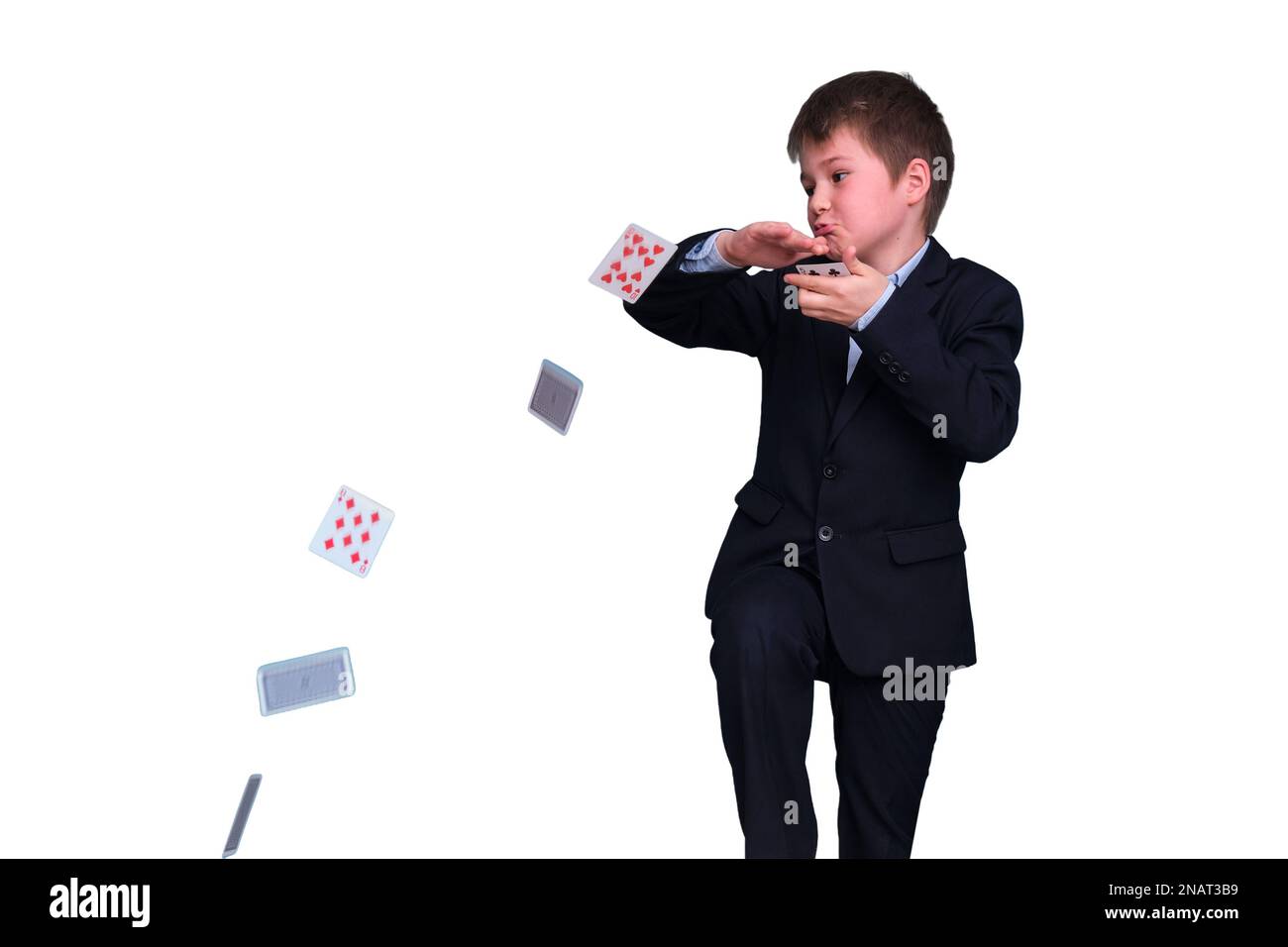 A happy boy in a school suit with playing cards in his hands on ...