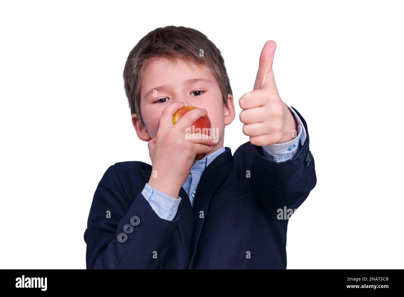 Pupil boy junior with an apple in his hands shows a gesture of approval ...