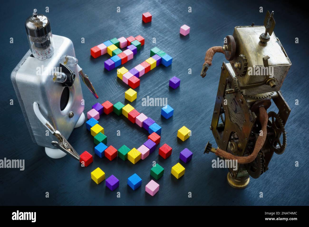 Two robots with brain from cubes and AI word Stock Photo - Alamy