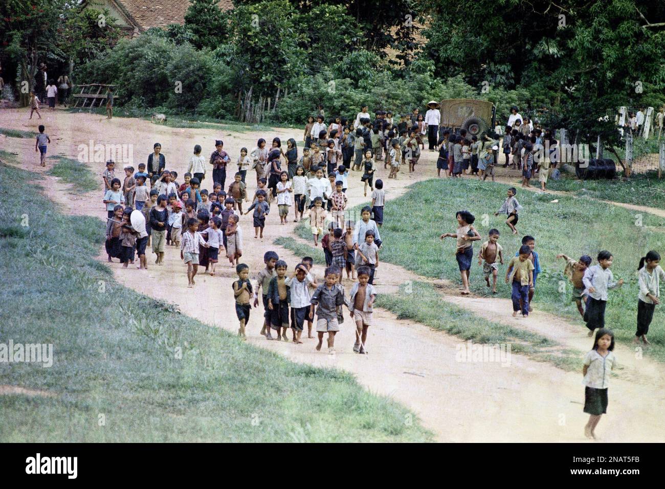 Sedang tribe of Montagnards, groups of children returning home from ...