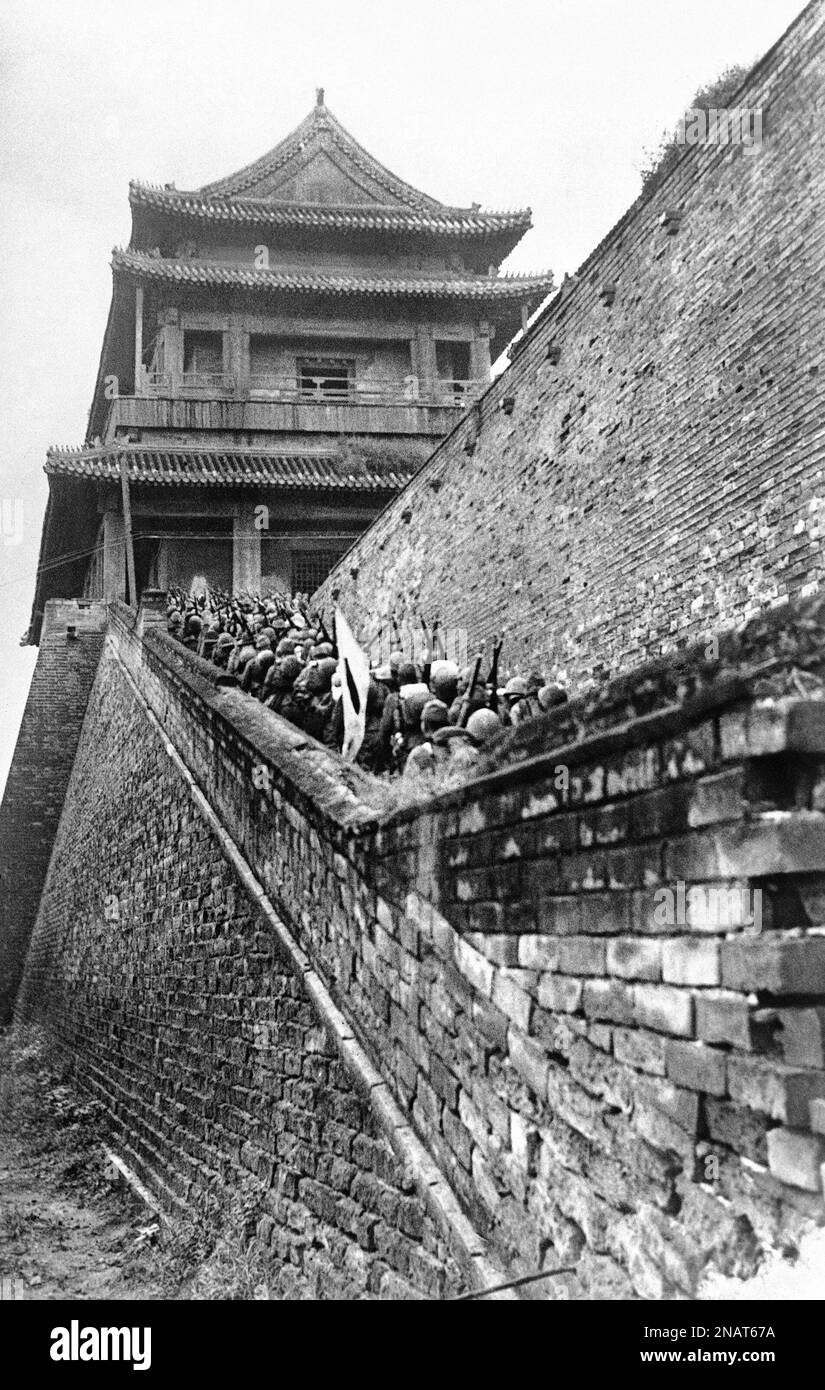 Japanese troops are seen ascending the ramps to the top of one of the ...