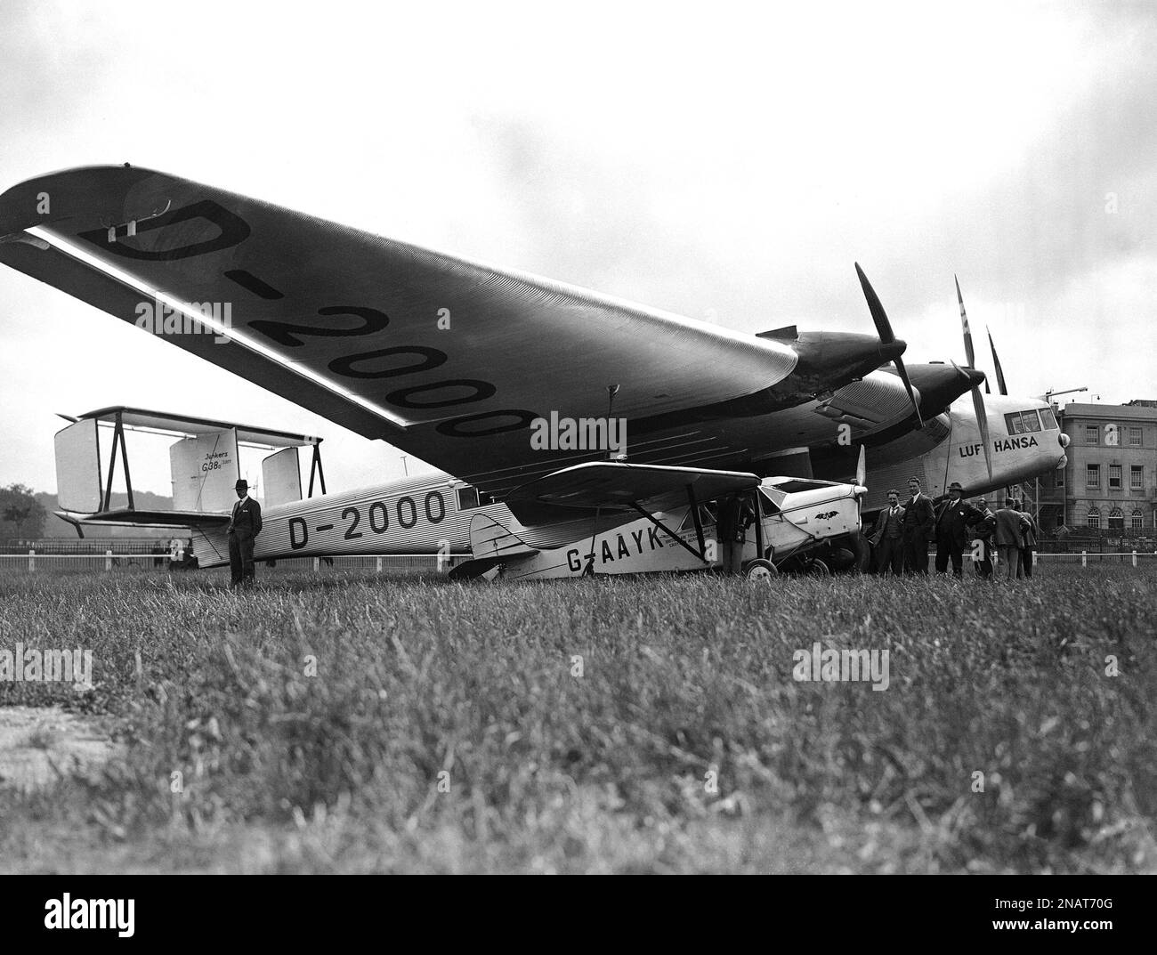 A giant Junkers D.2000 plane towers over a two seater plane during a ...