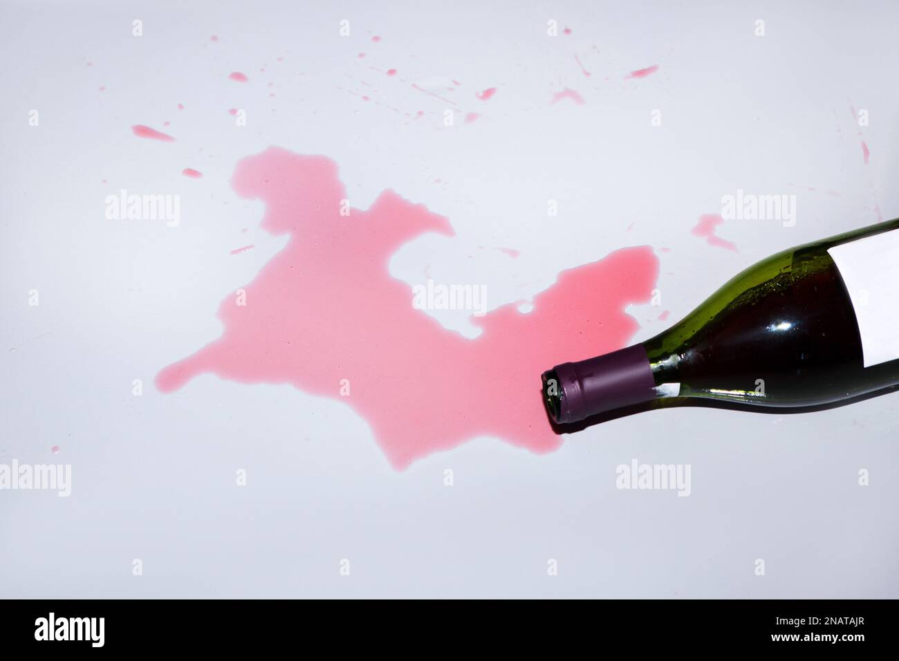 A bottle of red wine, knocked over on floor Stock Photo - Alamy