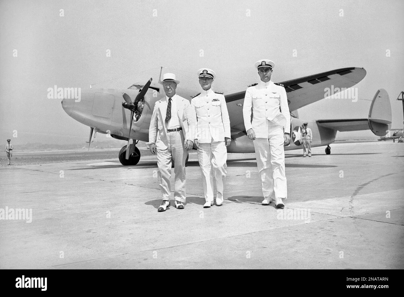 Secretary of the Navy Frank Knox, left, leaves his plane (background ...