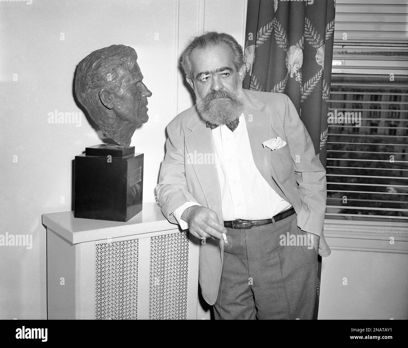 Sculptor Joe Davidson displays this bronze head of Vice President Henry ...