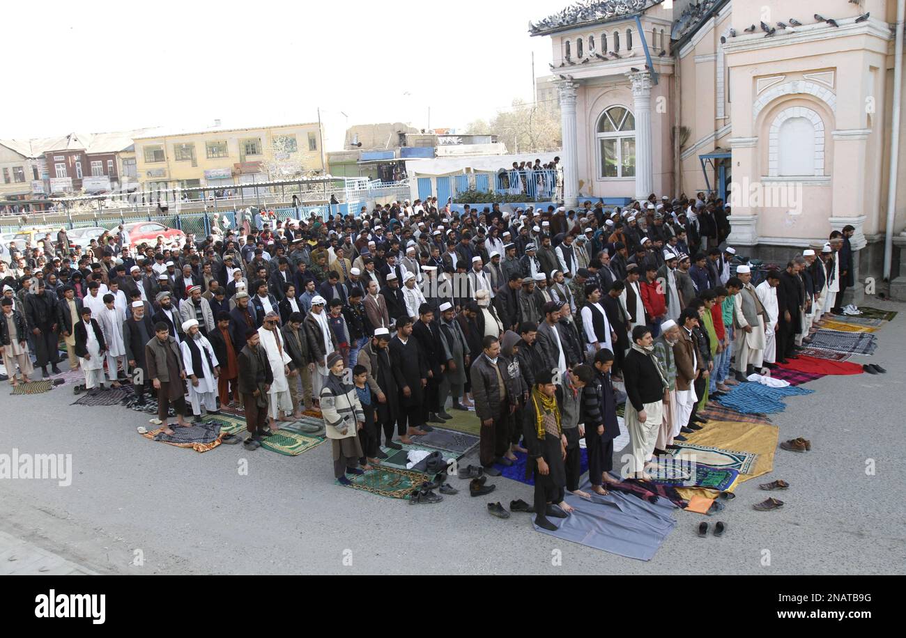 Afghan men offer prayers outside the shrine of Shah-E-Doshamshera, in ...