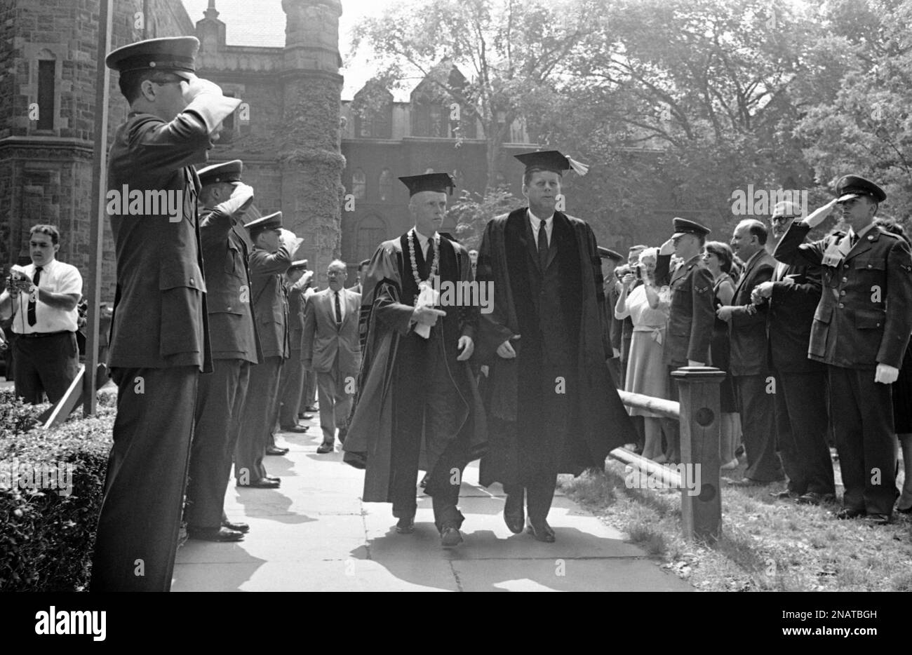 President John F. Kennedy, a Harvard graduate, walks with Yale ...