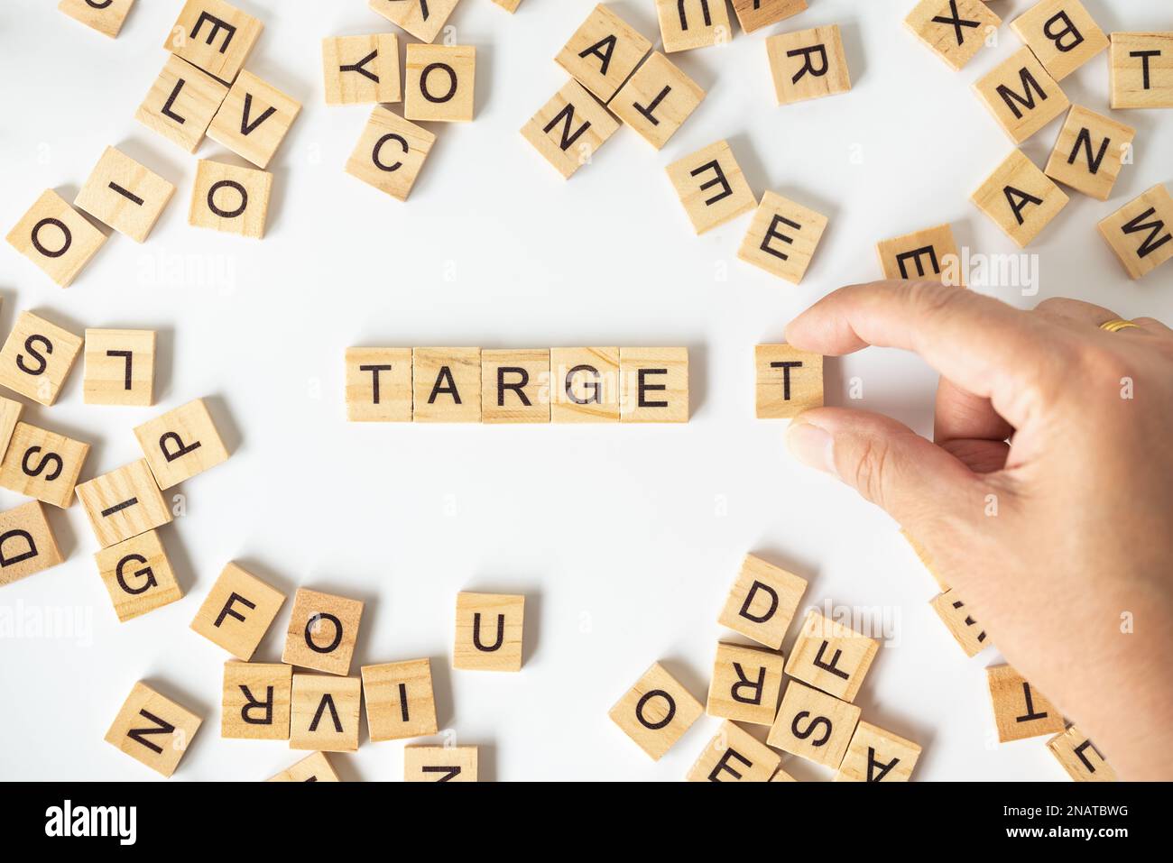 Business Concept. Closeup of man hand holding T wooden letter block to ...
