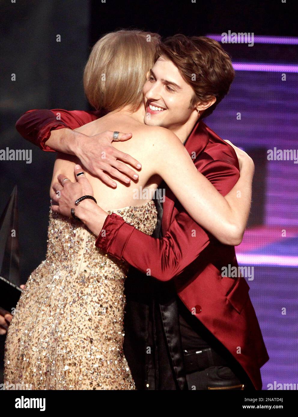 Ryan Follese, of Hot Chelle Rae, presents Taylor Swift with the award ...
