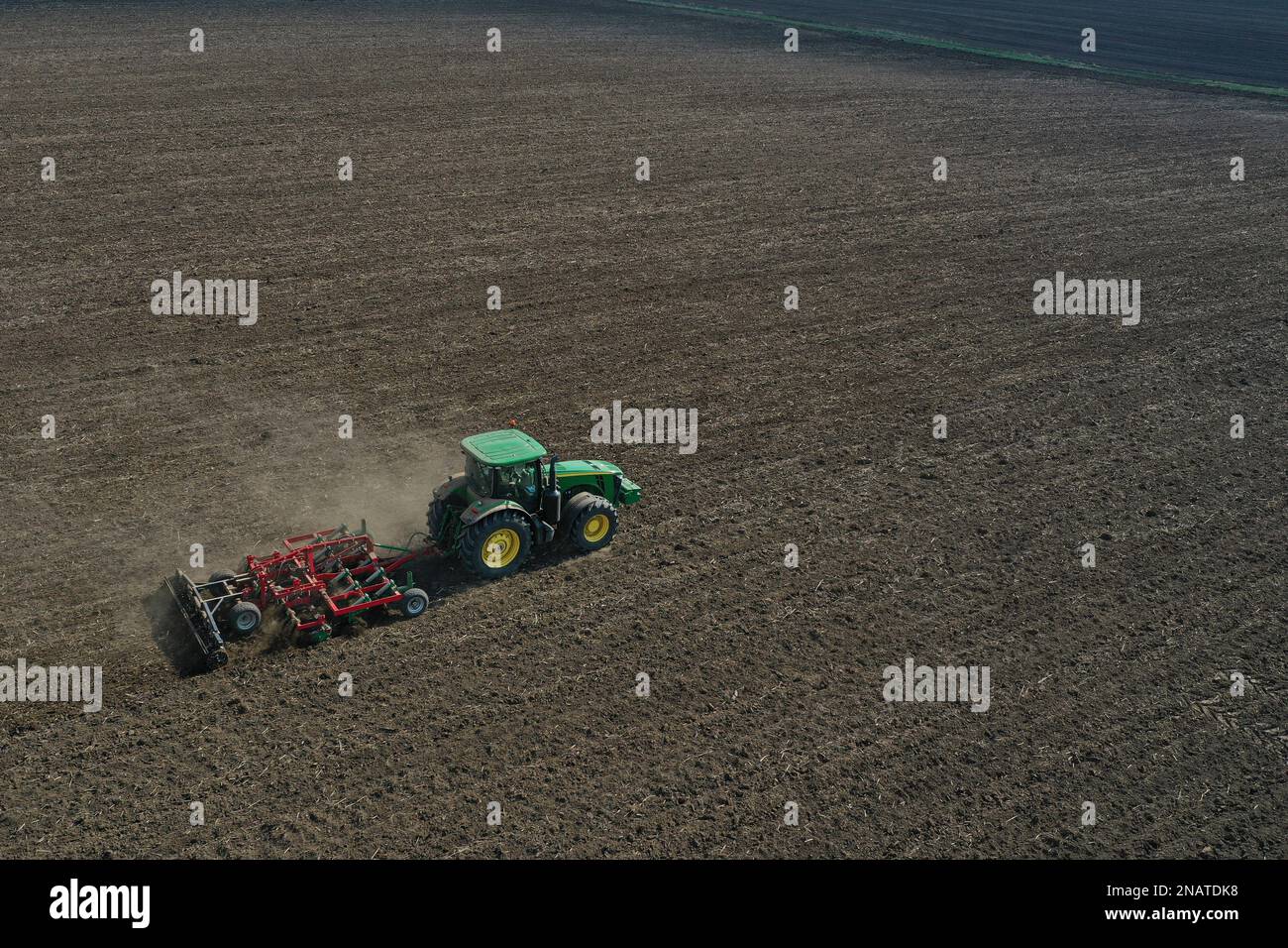 The farmer works with the tractor during the early spring season ...