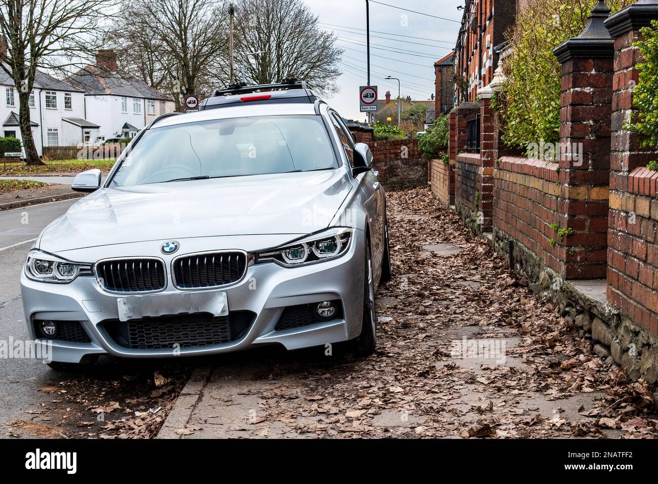 A car parked on a pavement, causing an obstruction for pedestrians ...