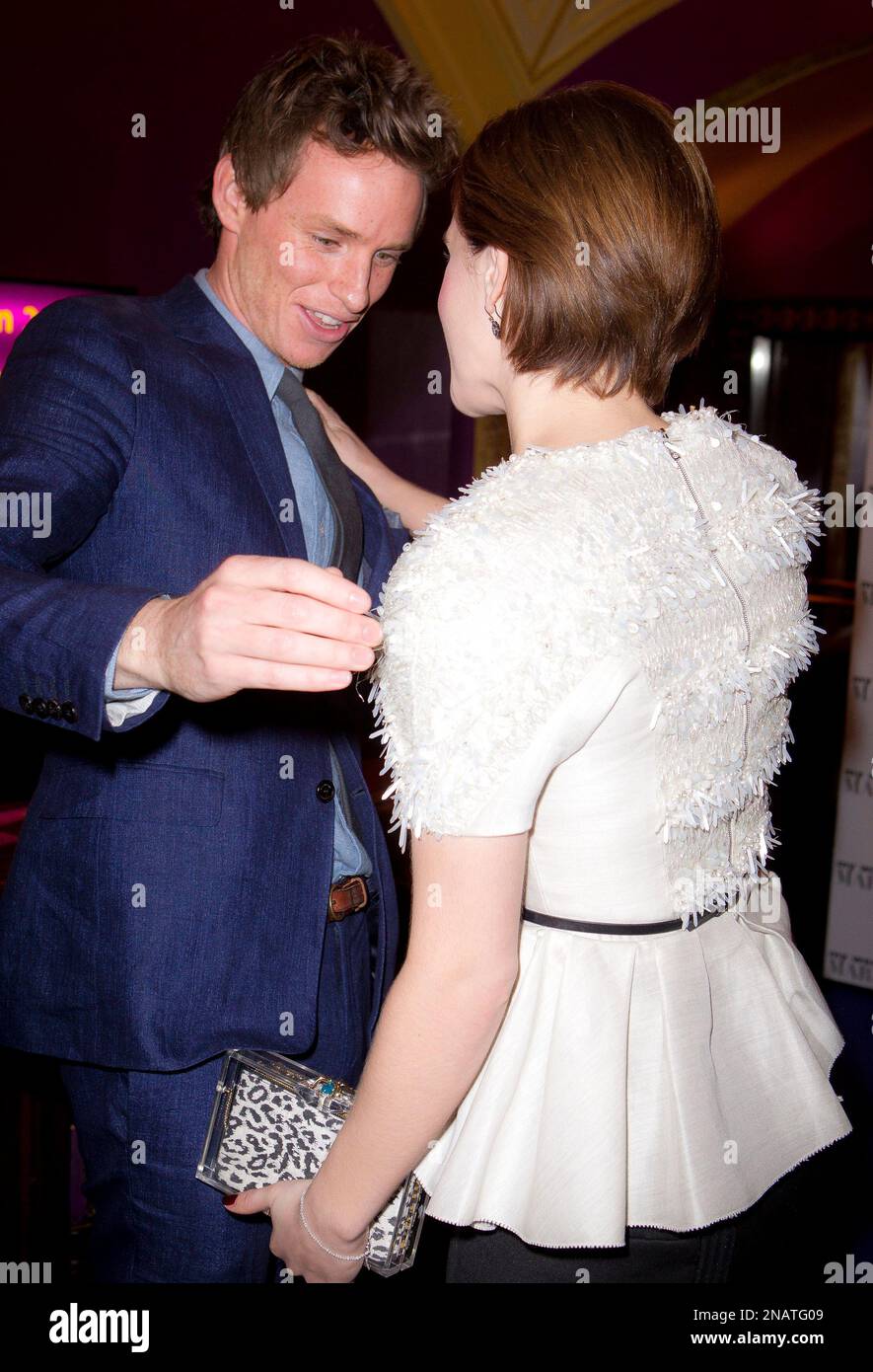 British actors Eddie Redmayne greets Emma Watson as they arrive for the ...