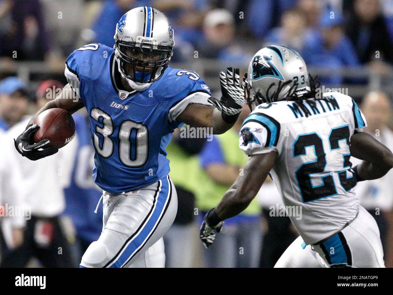 Detroit Lions running back Kevin Smith (30) stiff-arms Carolina ...