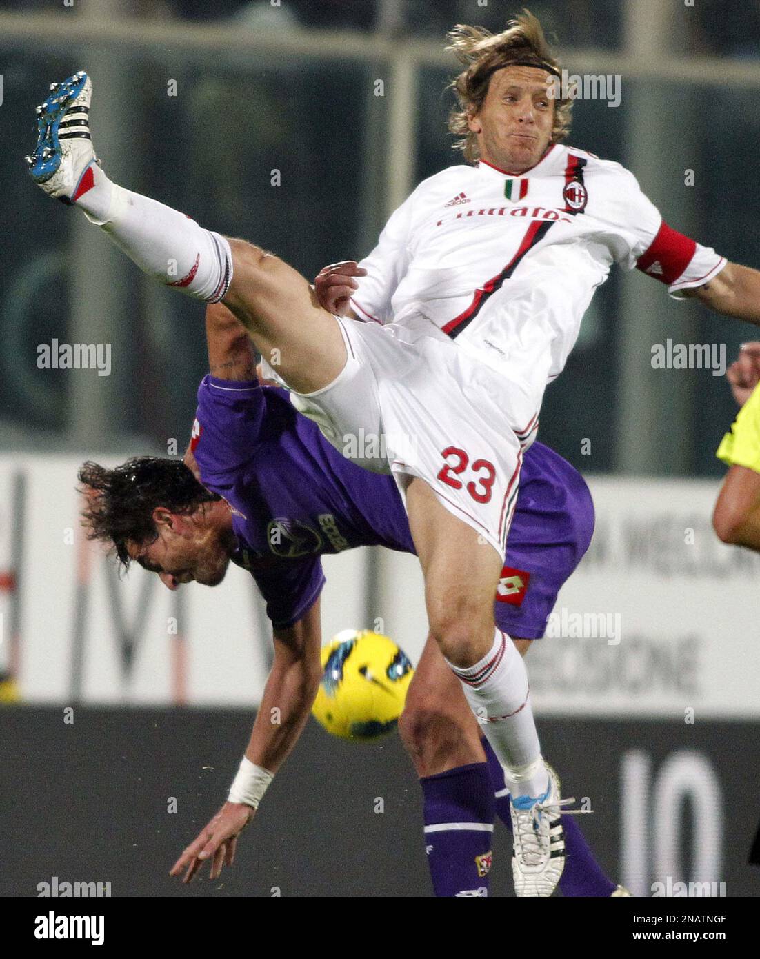 Fiorentina's Gianni Munari is challenged by Milan's Massimo Ambrosini ...