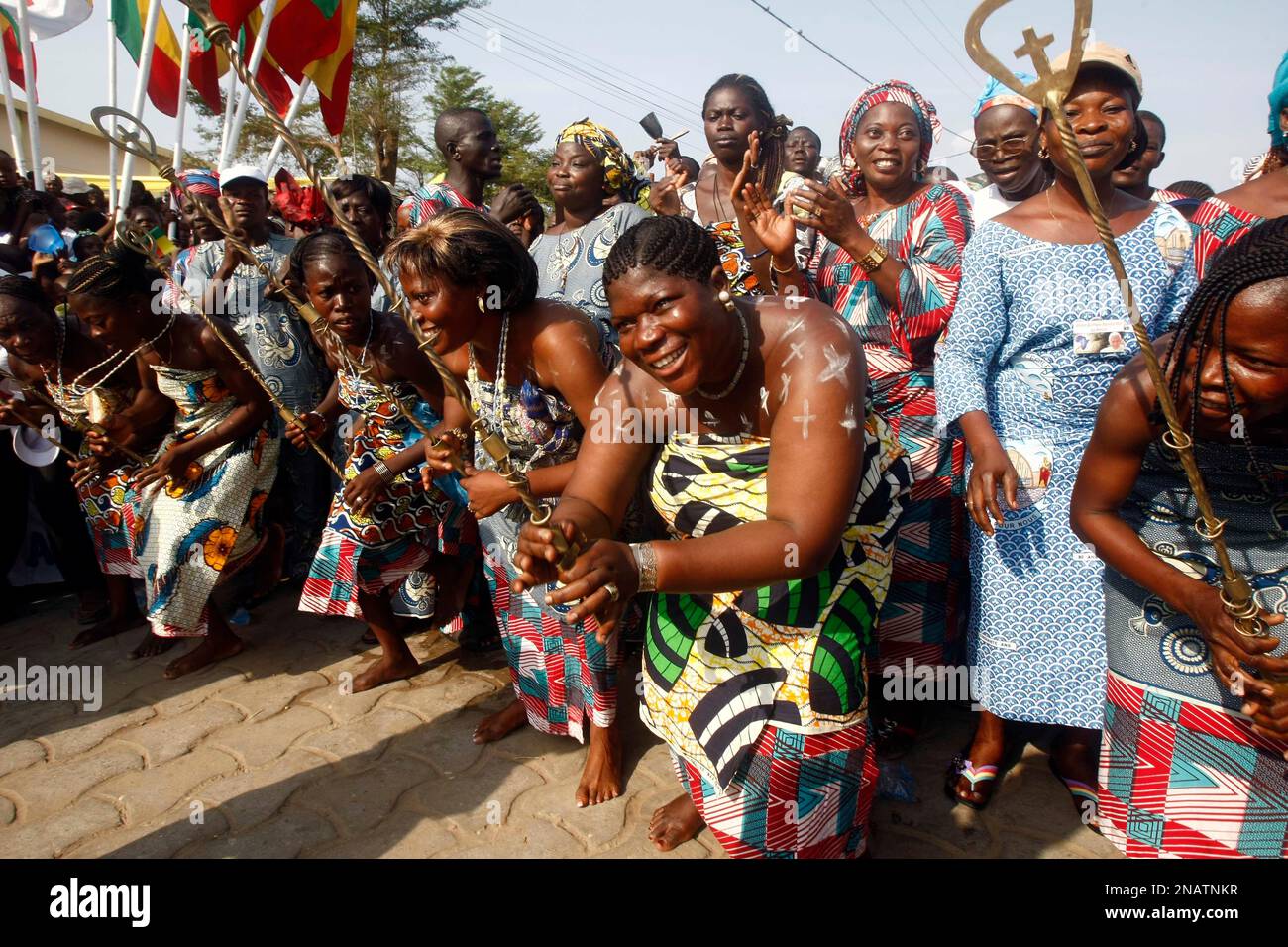 Women dance and play handmade instruments as they wait for the arrival ...