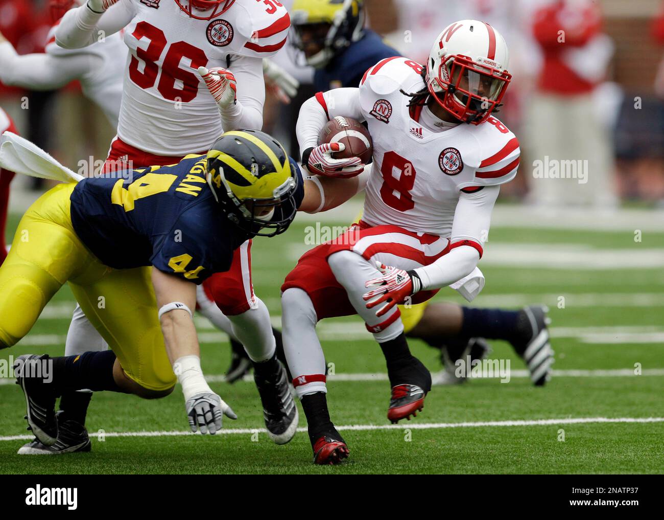 Nebraska running back Ameer Abdullah (8) is stopped by Michigan ...