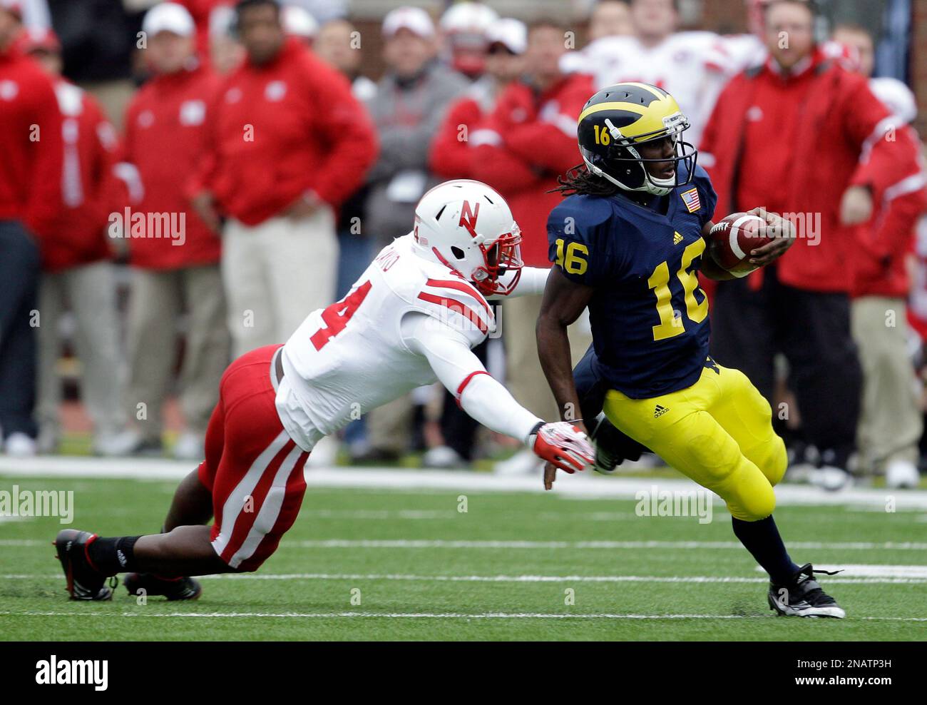 Michigan quarterback Denard Robinson (16) is chased by Nebraska ...
