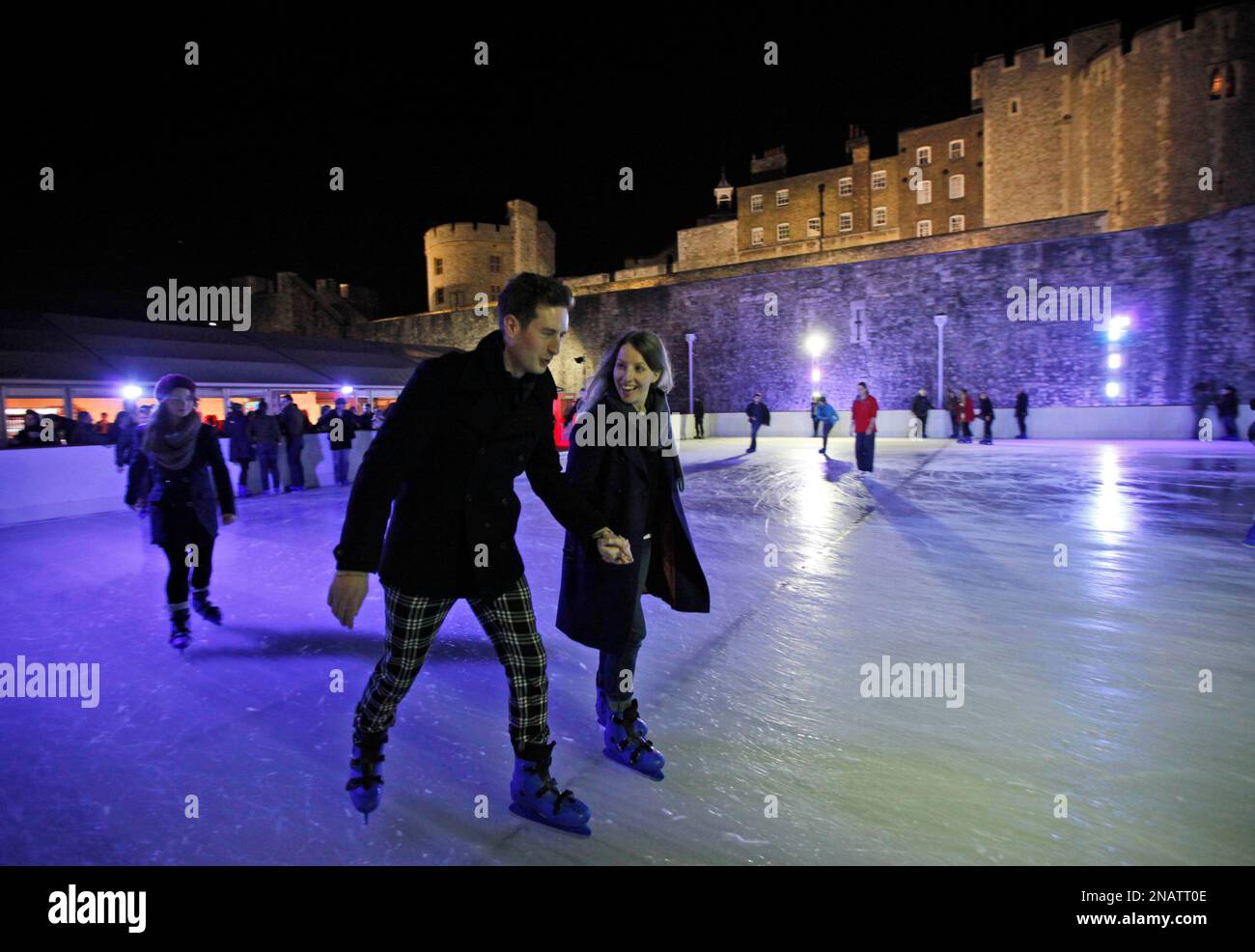 Skaters enjoy playing on the ice rink which has been set up in the moat ...