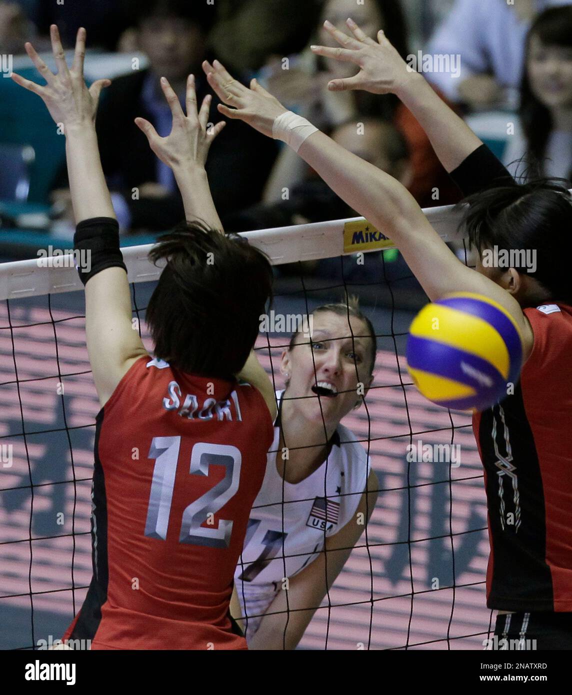 Jordan Larson of the U.S. spikes the ball against Saori Kimura, left ...