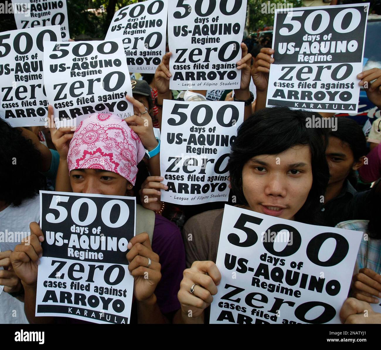 Protesters shout slogans and display messages against former Philippine ...