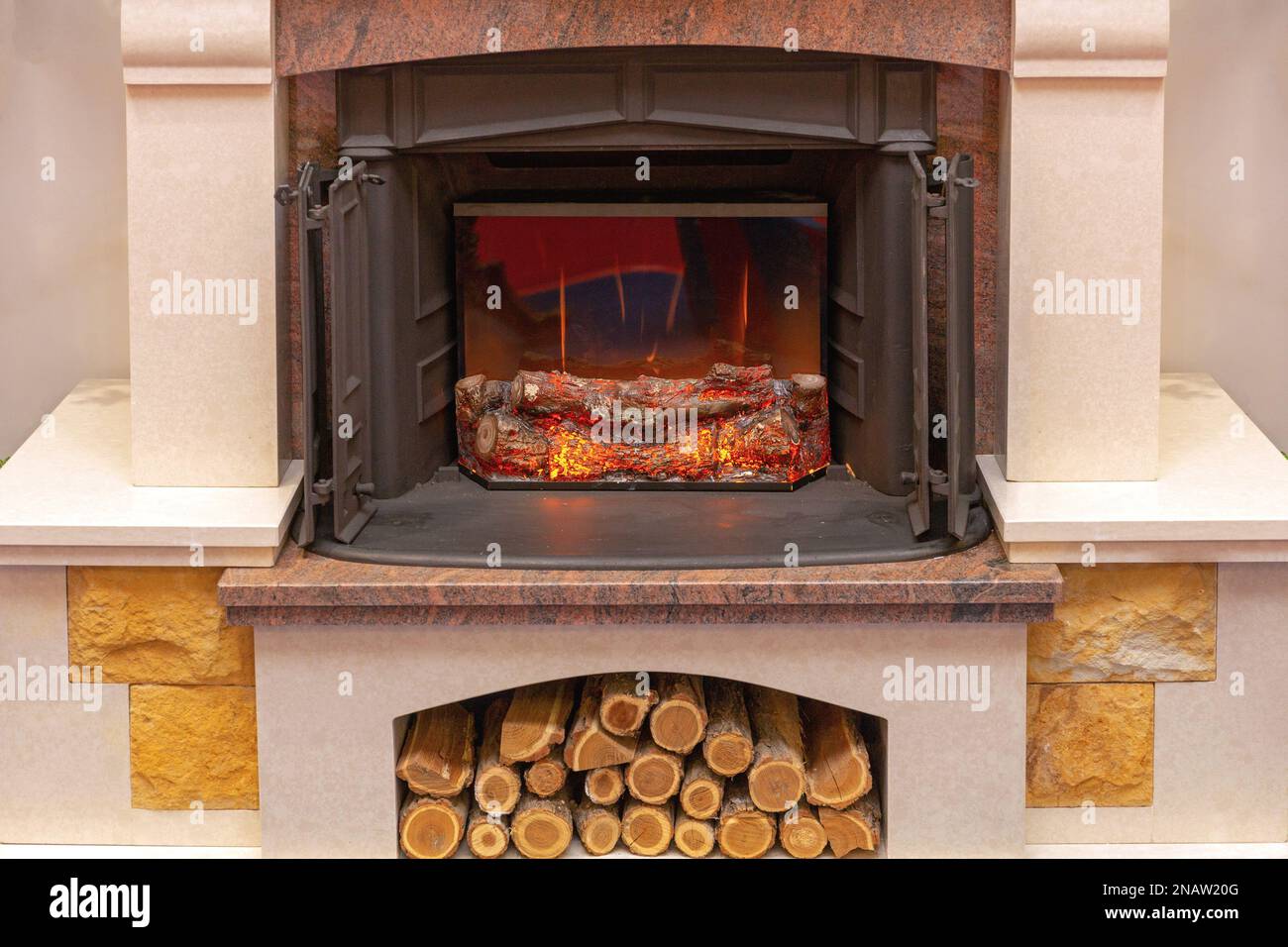 Electronic Fireplace With Ceramic Wood Logs in Home Stock Photo - Alamy
