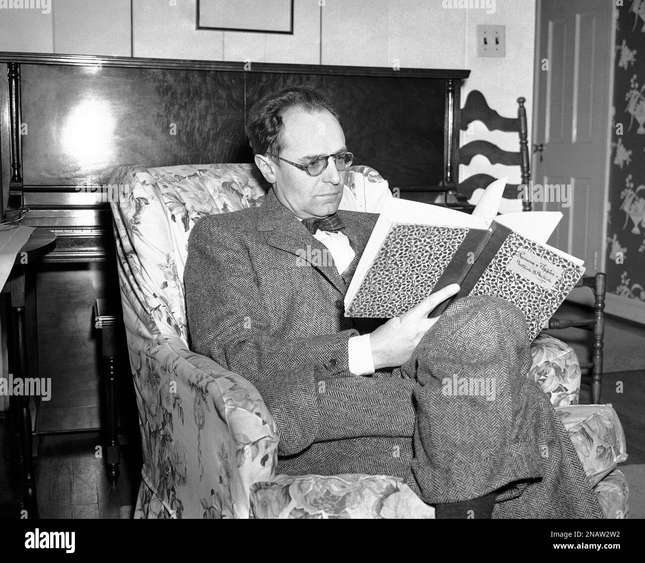 With lots of time on his hands, Pierre Cot reads in his home in a ...
