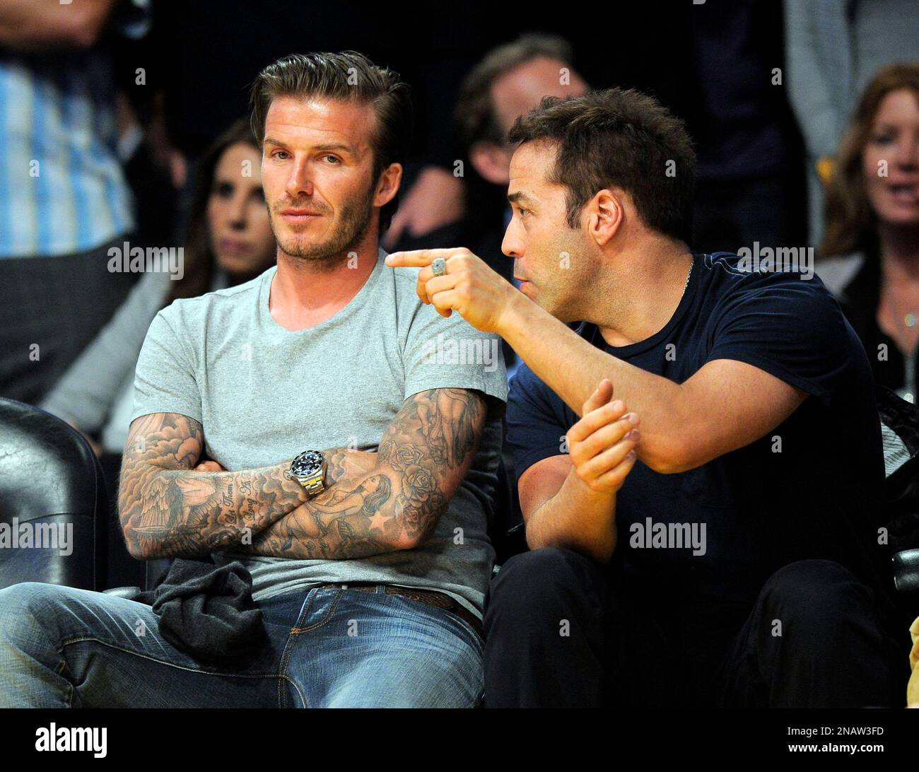 Soccer star David Beckham, left, and actor Jeremy Piven talk during ...